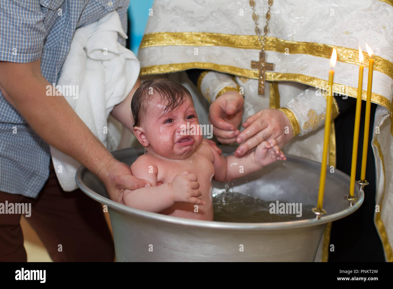 Baptism of a child. Ablution in holy water. Accepting faith. Orthodox ...