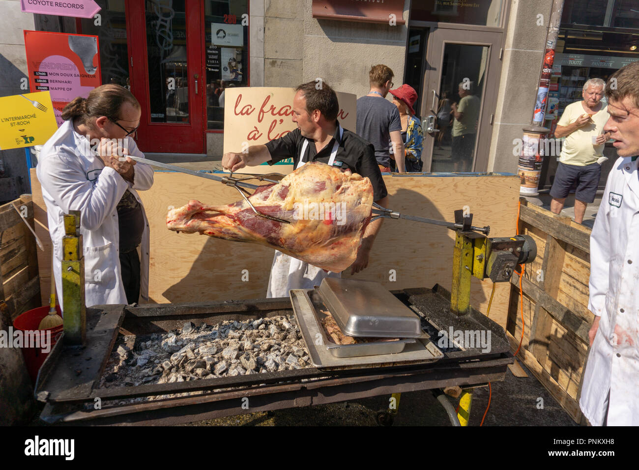 Saint-Roch XP street festival in Quebec City with men roasting a ...