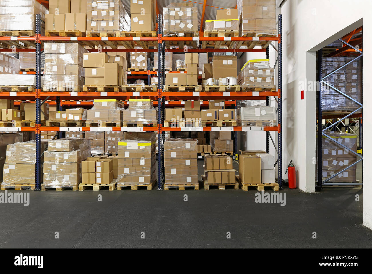 Boxes and crates at shelves in distribution warehouse Stock Photo - Alamy
