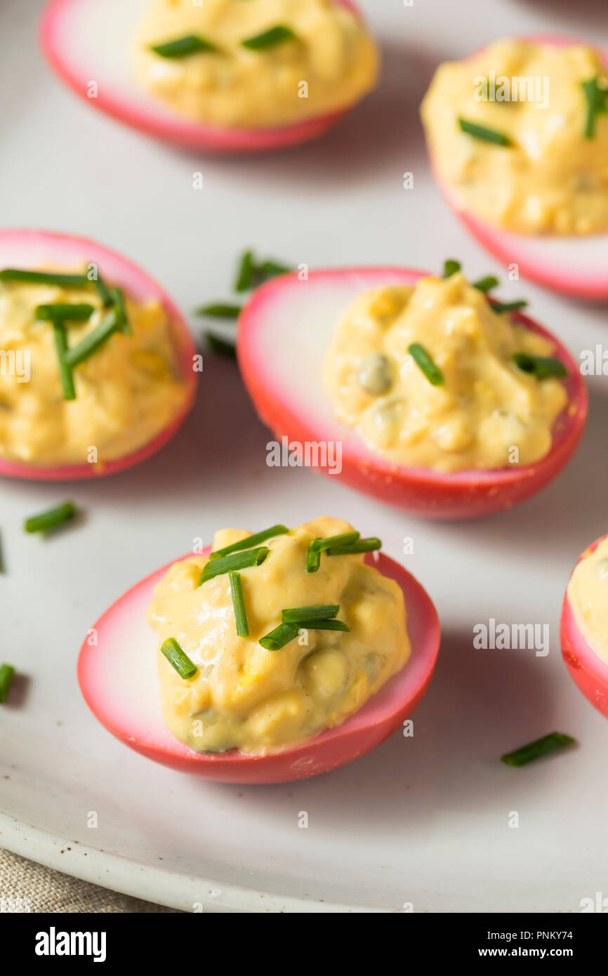 Homemade Pink Pickled Deviled Eggs with Chives Stock Photo - Alamy