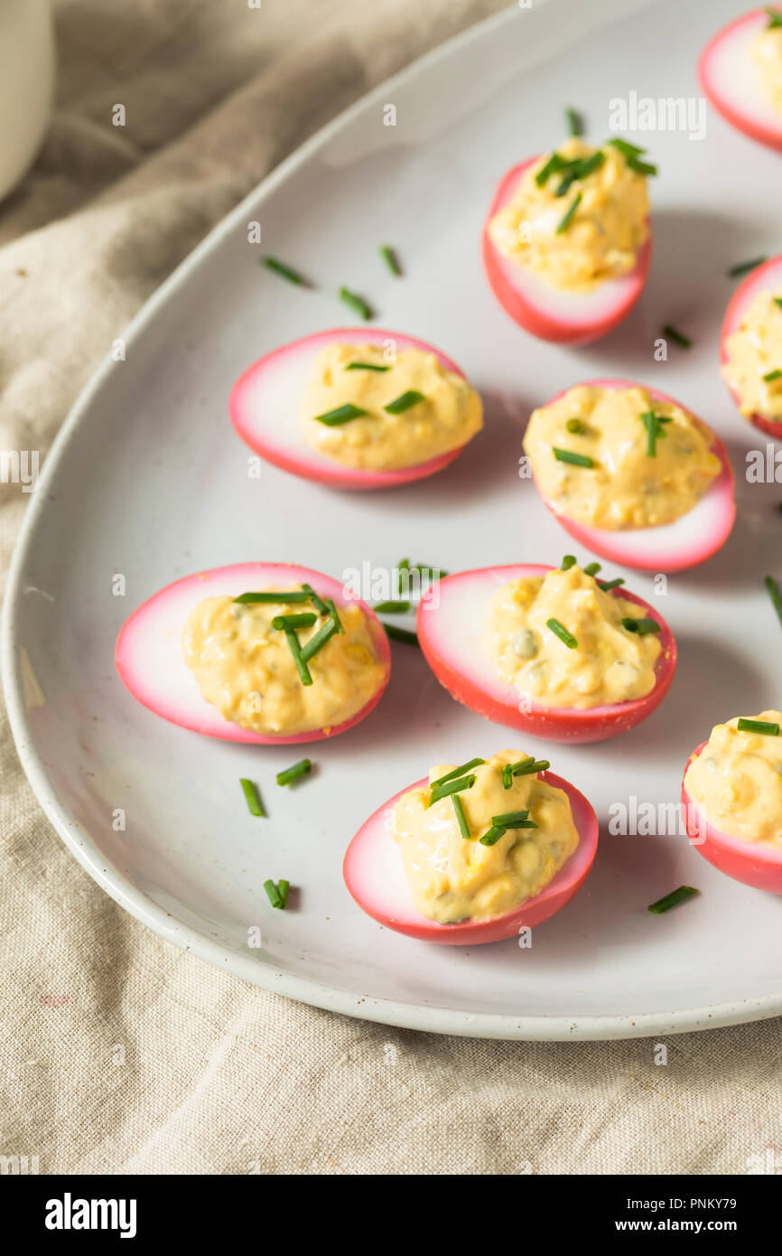 Homemade Pink Pickled Deviled Eggs with Chives Stock Photo - Alamy