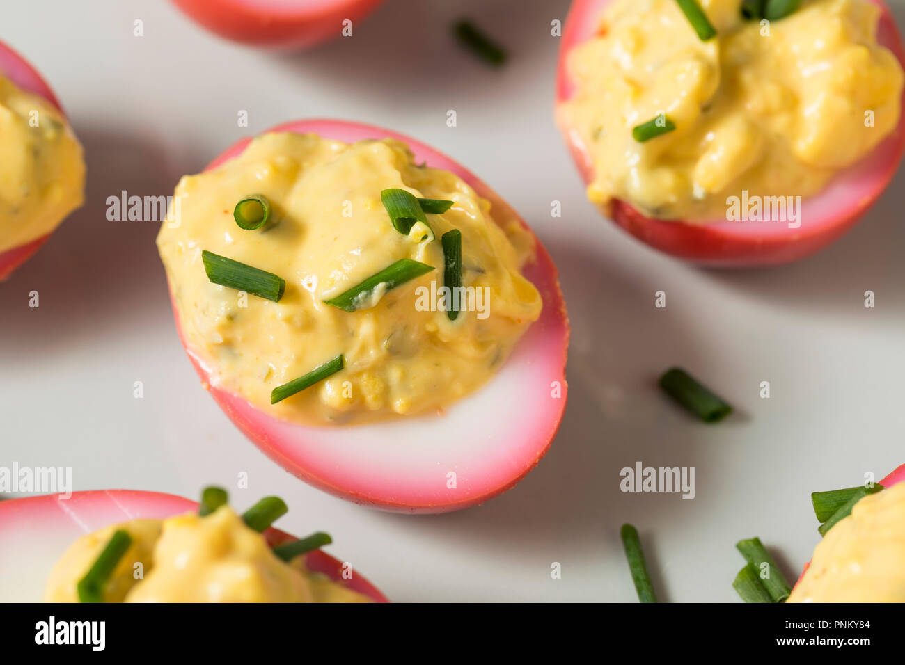 Homemade Pink Pickled Deviled Eggs with Chives Stock Photo - Alamy