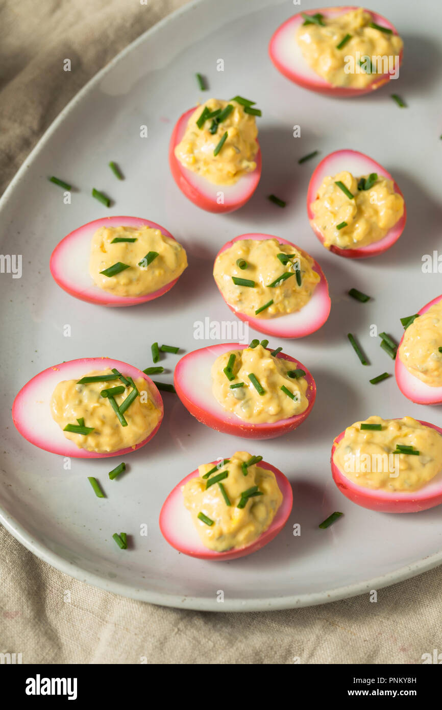 Homemade Pink Pickled Deviled Eggs with Chives Stock Photo - Alamy