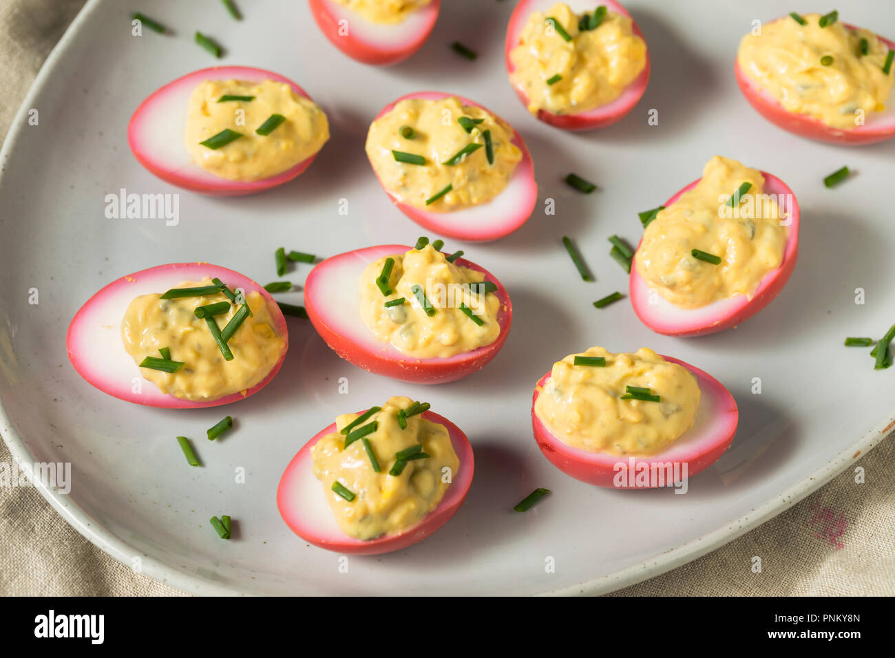 Homemade Pink Pickled Deviled Eggs with Chives Stock Photo - Alamy