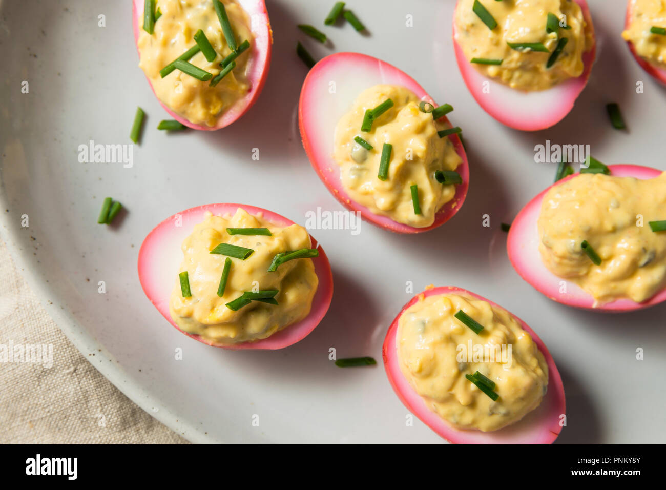 Homemade Pink Pickled Deviled Eggs with Chives Stock Photo - Alamy