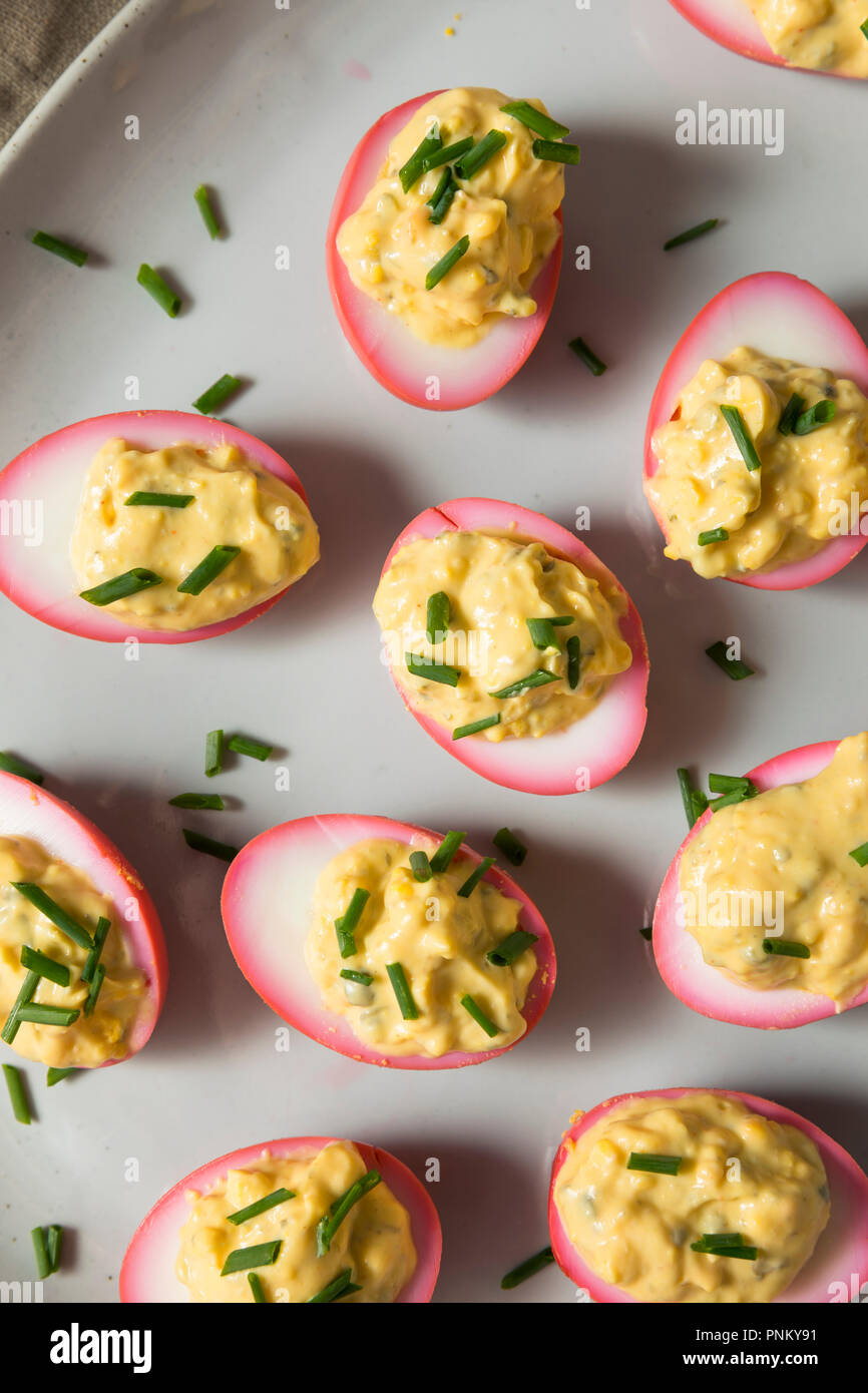 Homemade Pink Pickled Deviled Eggs with Chives Stock Photo - Alamy