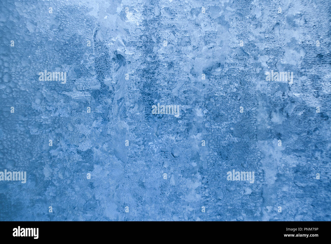 Natural blue winter frosty icy pattern on window pane Stock Photo - Alamy