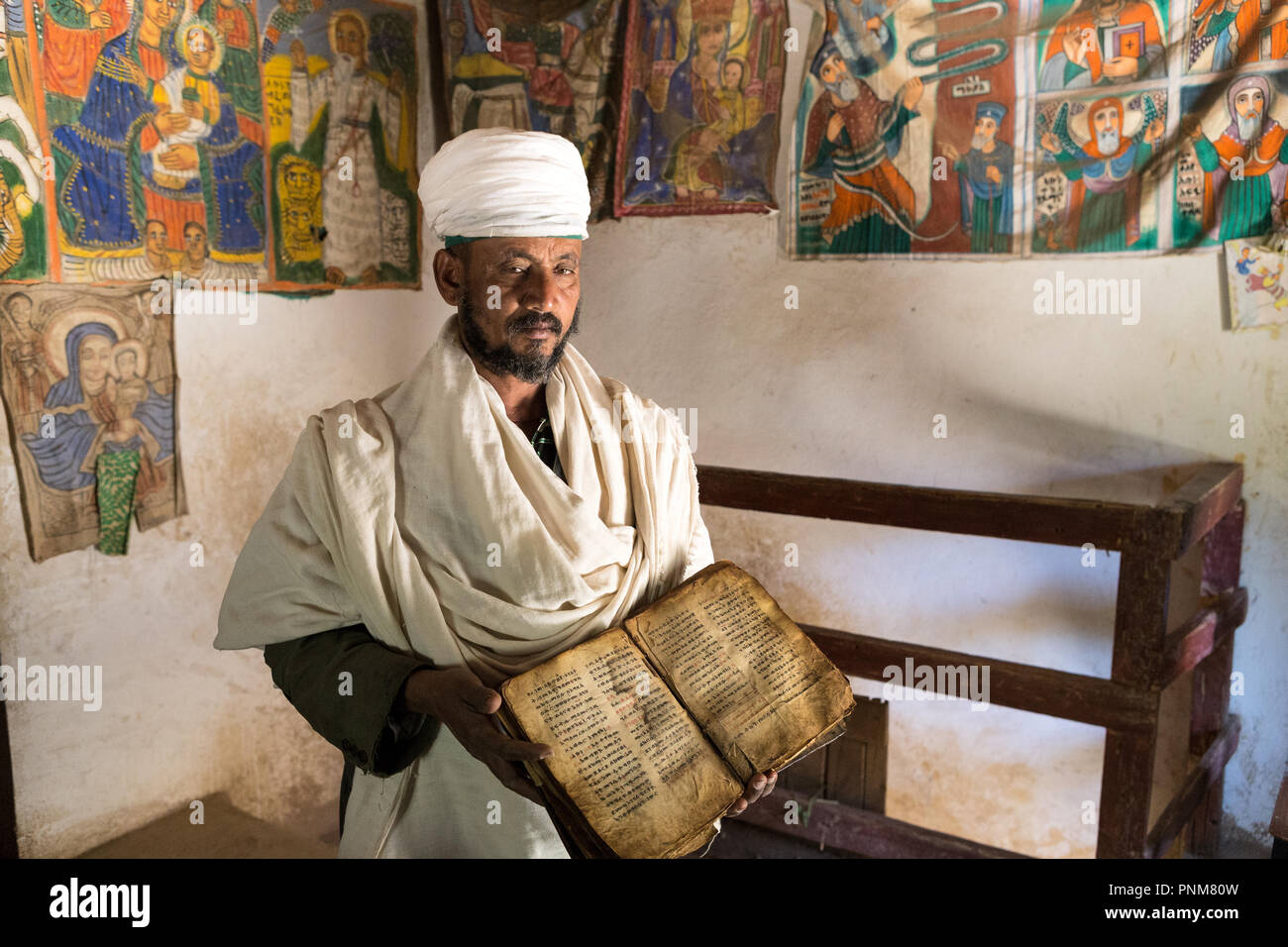 Monk and 300 year old New testament bible. Yeha Monastery, Ethiopia ...