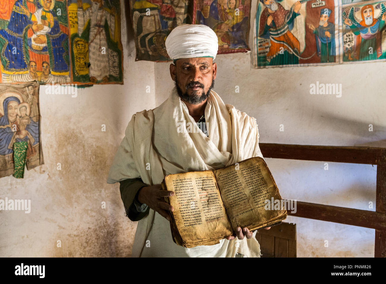 Monk and 300 year old New testament bible. Yeha Monastery, Ethiopia ...