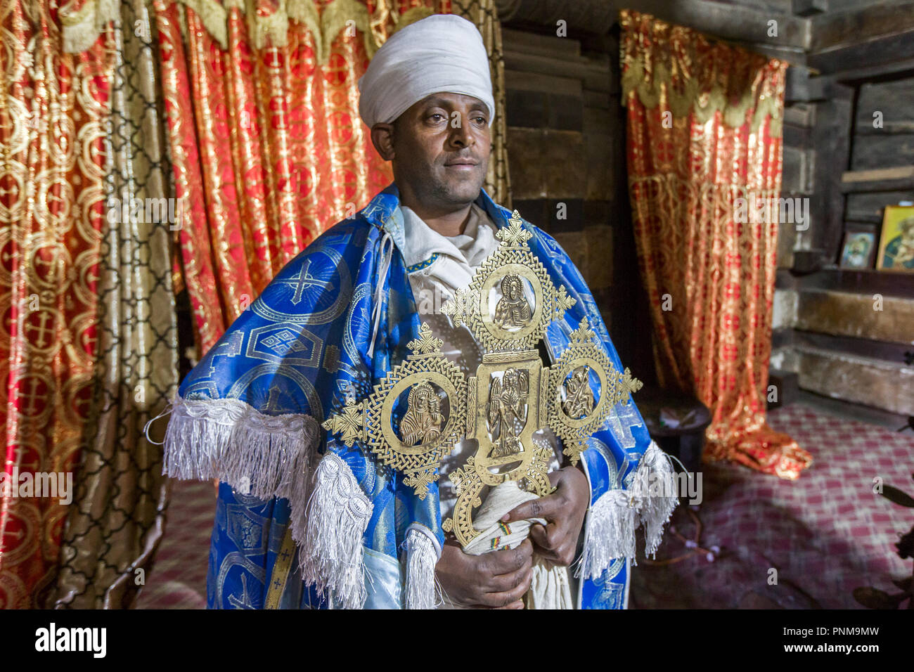 Priest with cross: Yemrehanna Kristos Monastery, Lalibela, Ethiopia ...