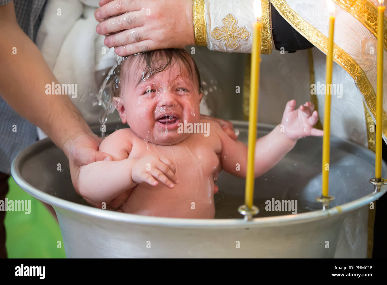 Baptism of a child. Ablution in holy water. Accepting faith. Orthodox ...