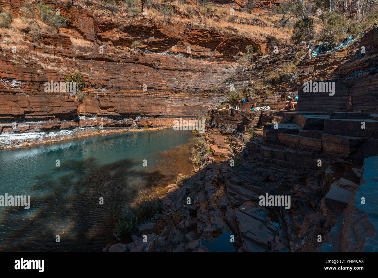 People relaxing on the rocks at, Fortescue falls, Dales Gorge, Karijini ...