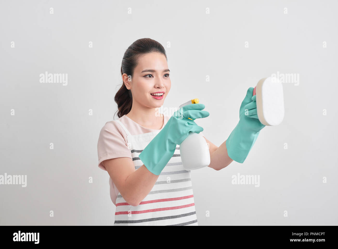 Beautiful cheerful woman holding different cleaning stuff. Isolated ...