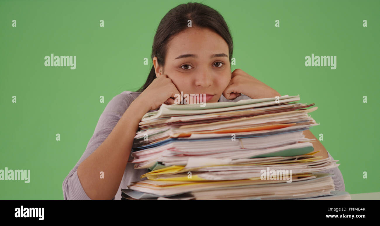 Overworked business professional with pile of paperwork upset on ...