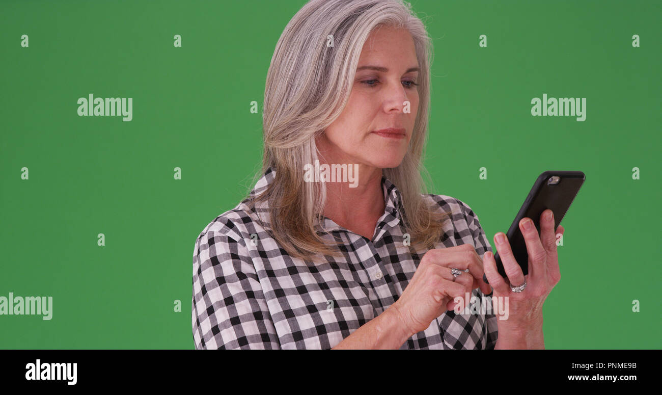Closeup of mid-aged caucasian woman on a handheld cellular device Stock ...