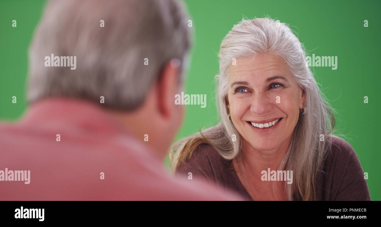 Lovely mature caucasian woman flirting with a white male on green ...