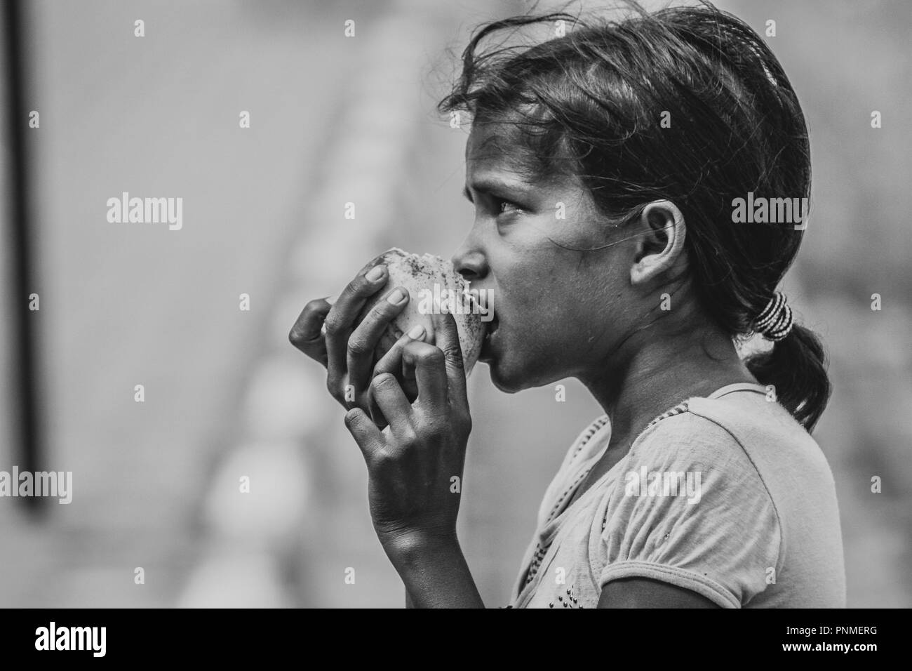 Sri Lankan poor street girl eating a mango at Tissamaharama Stock Photo ...