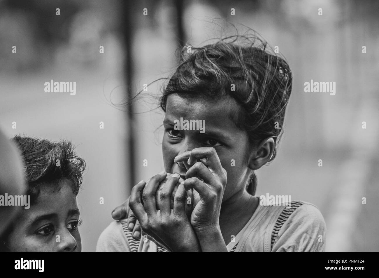 Sri Lankan poor street girl eating a mango at Tissamaharama Stock Photo ...