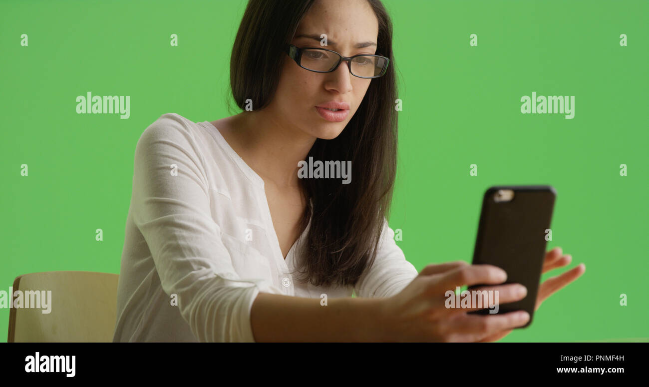 A Hispanic woman receiving concerning text message green screen Stock ...