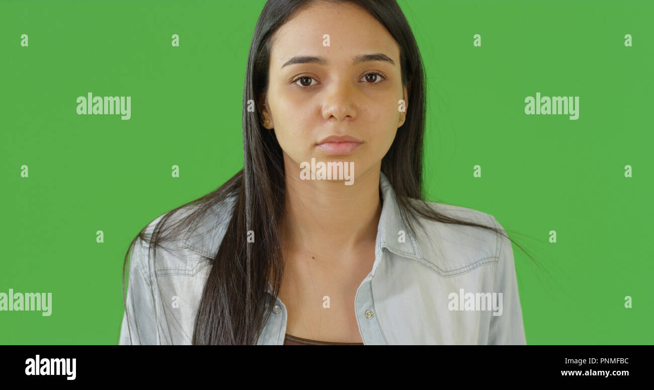 A young girl dramatically stares into the camera on green screen Stock ...