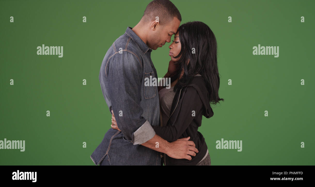 Young black about to kiss each other on green screen Stock Photo - Alamy