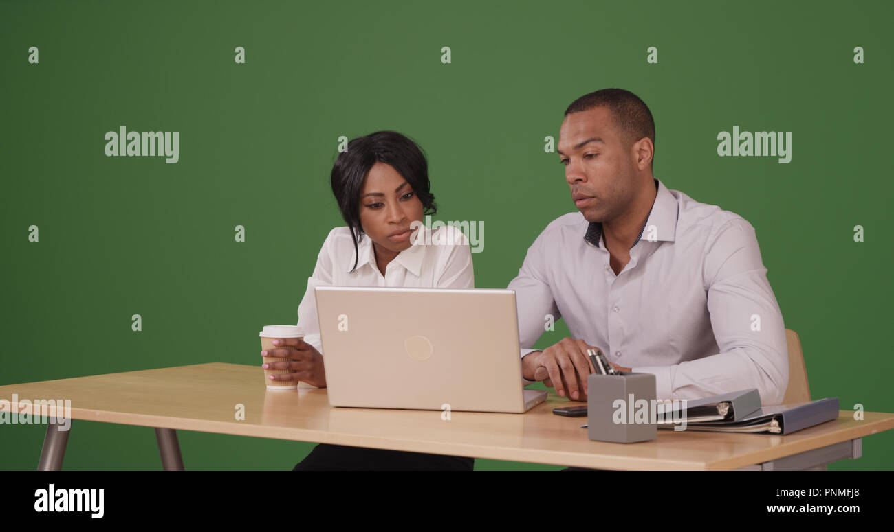 Two business people working together at laptop on green screen Stock ...