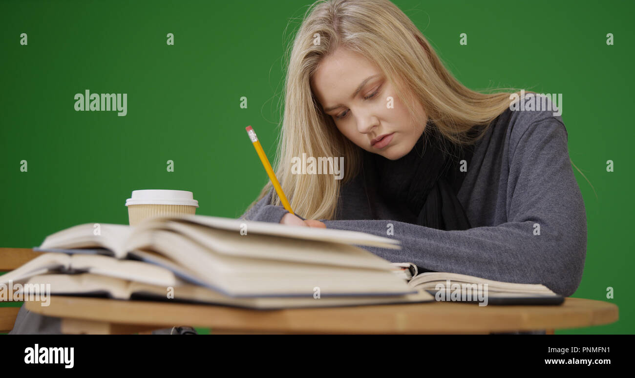 A young white girl studies for her finals on green screen Stock Photo ...