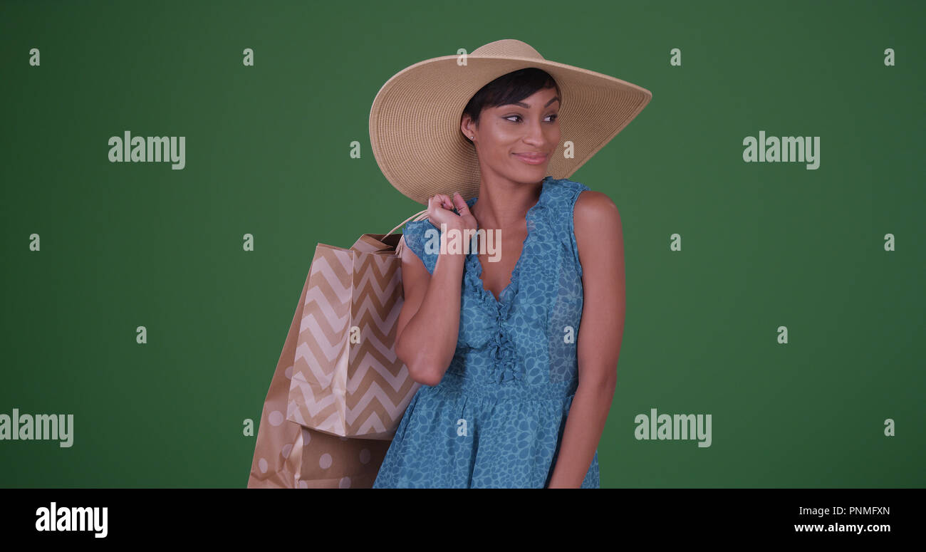 Pretty black female shopper on green screen Stock Photo - Alamy