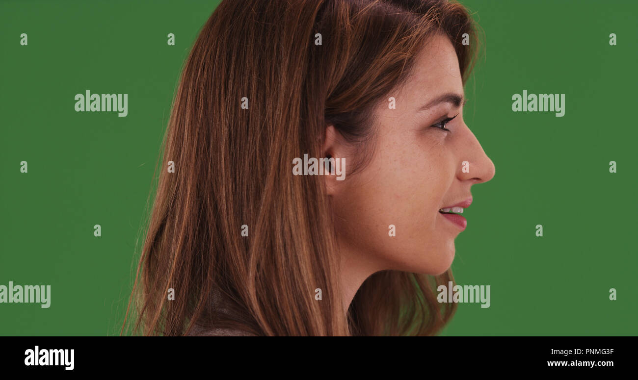 Side profile of gorgeous brunette girl on green screen Stock Photo - Alamy