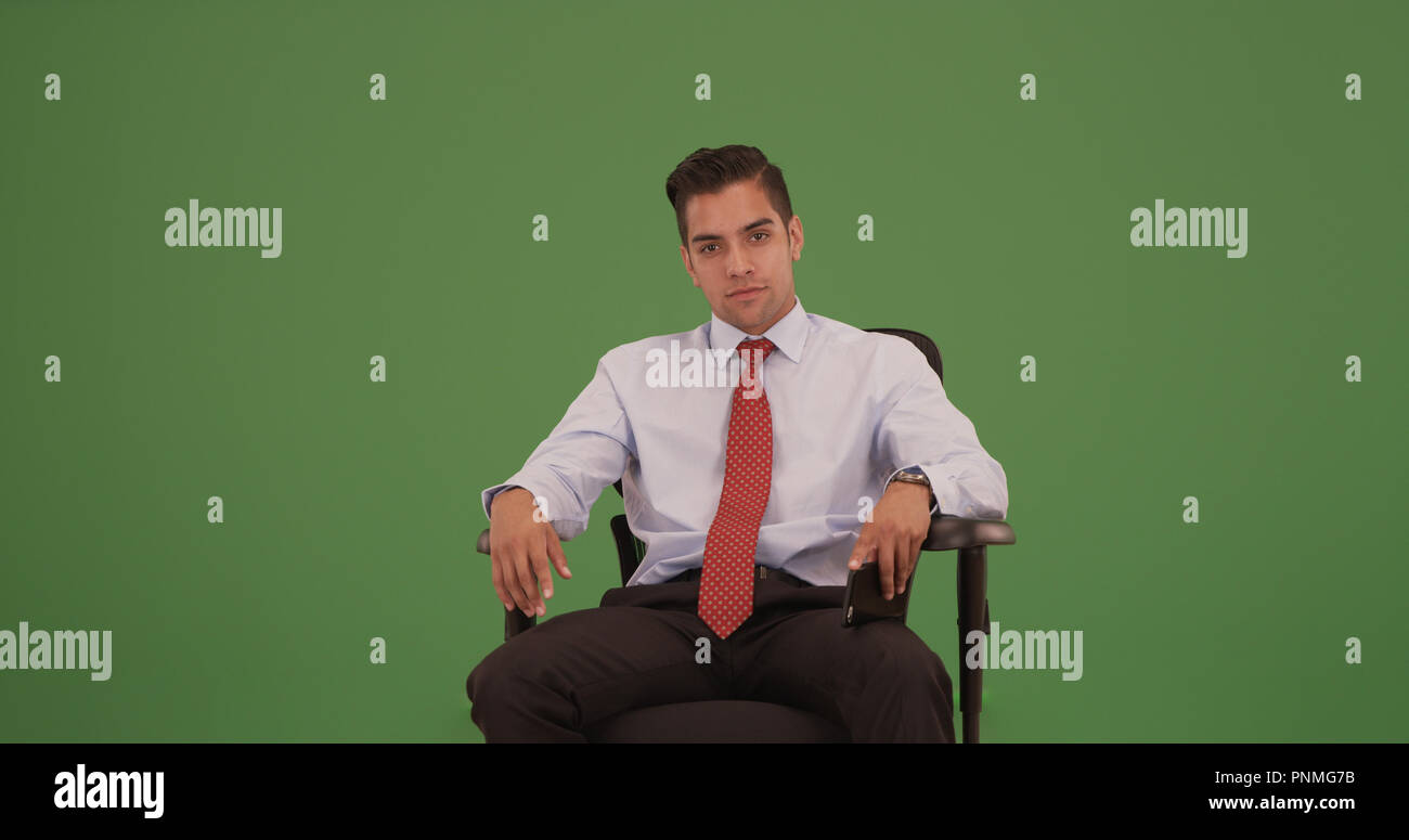 Young professional looking at camera on green screen Stock Photo - Alamy