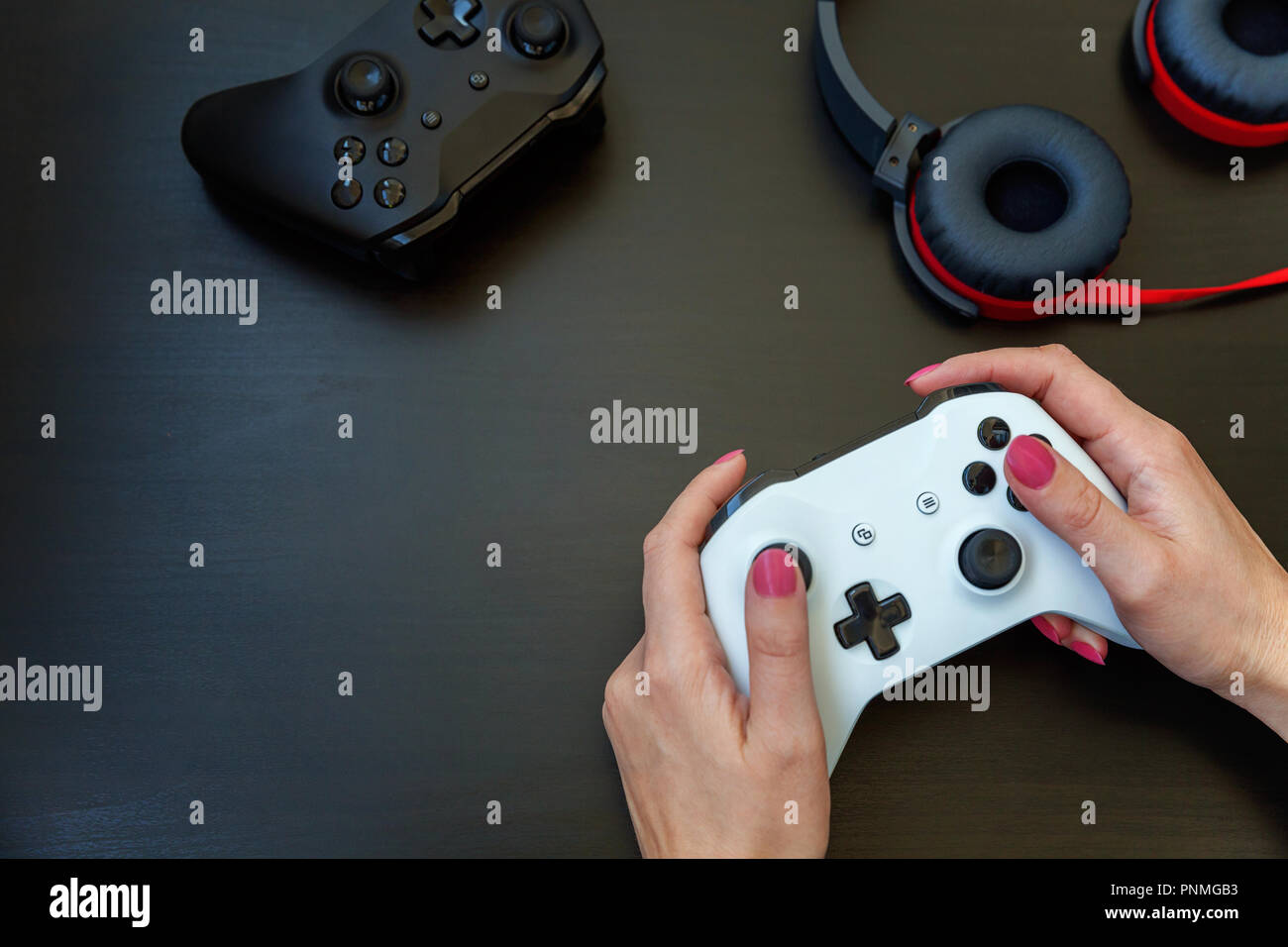 Woman hand holding white joystick gamepad, game console on black ...