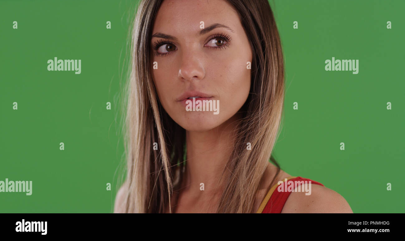 Close up millennial hipster woman in red top looking off screen on ...