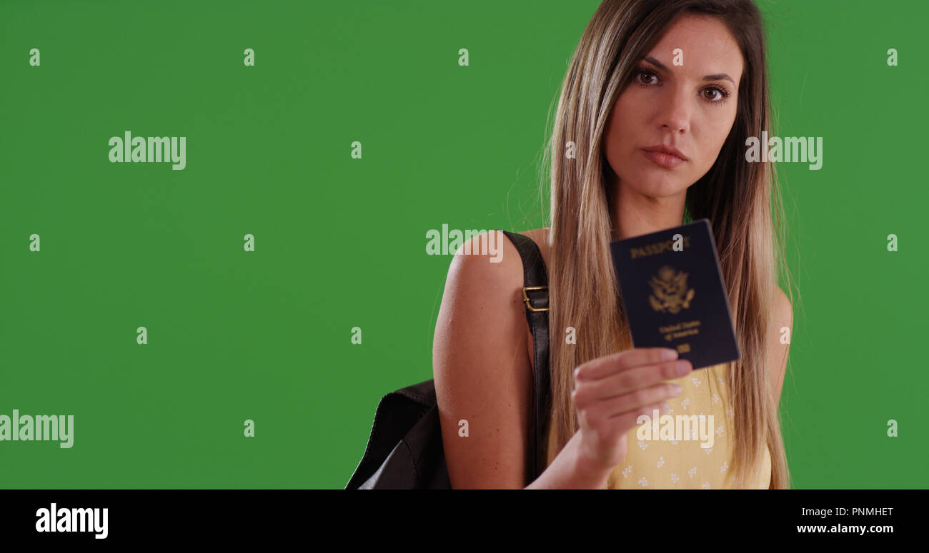 Portrait of Millennial woman traveler showing her US Passport on ...