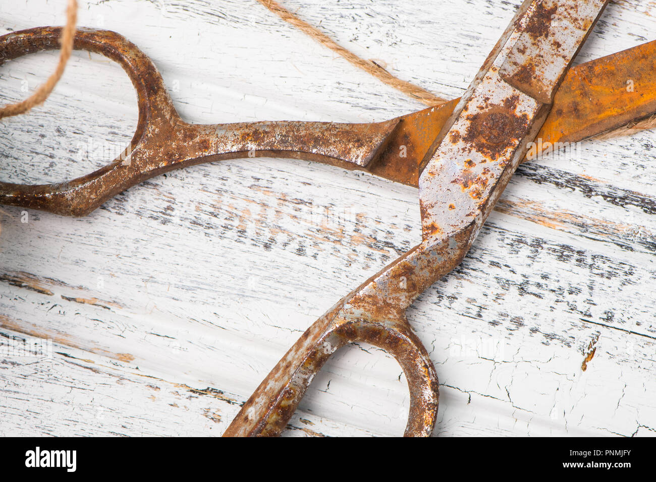 Old scissors on peeled paint background Stock Photo - Alamy