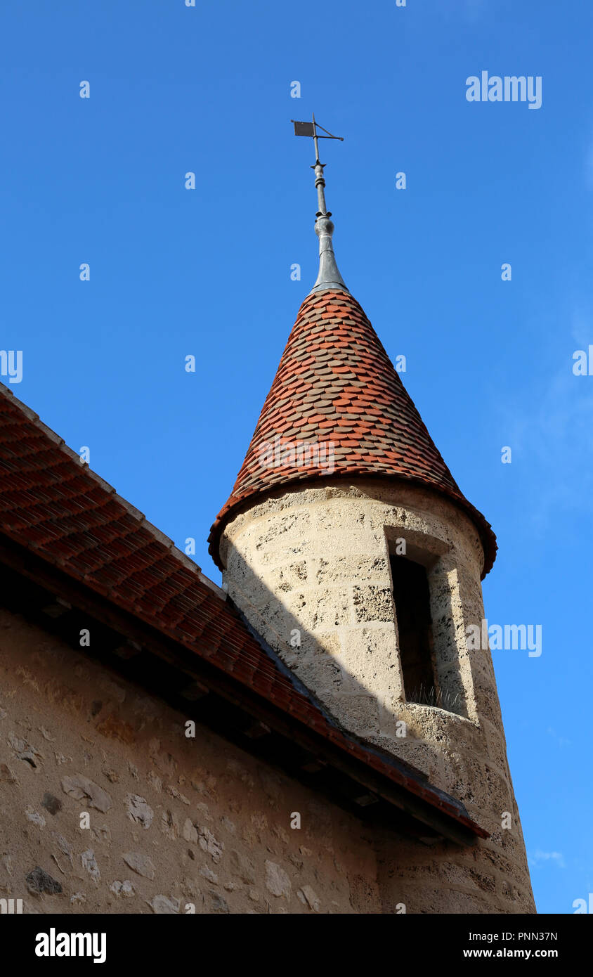 Ancient medival turrent and blue sky in summer with small weathervane ...