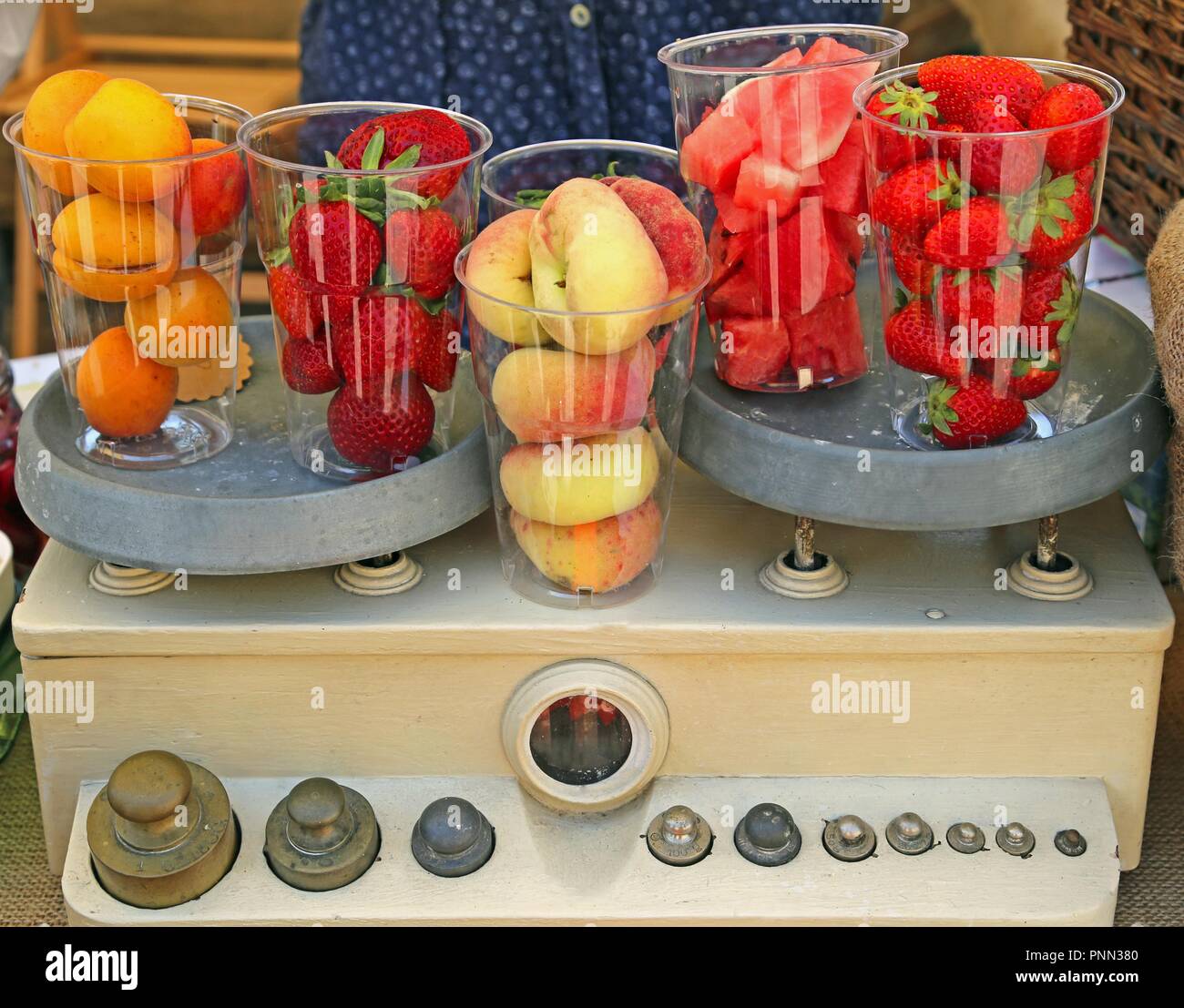 ancient scales with filled glassware of fruit Stock Photo - Alamy