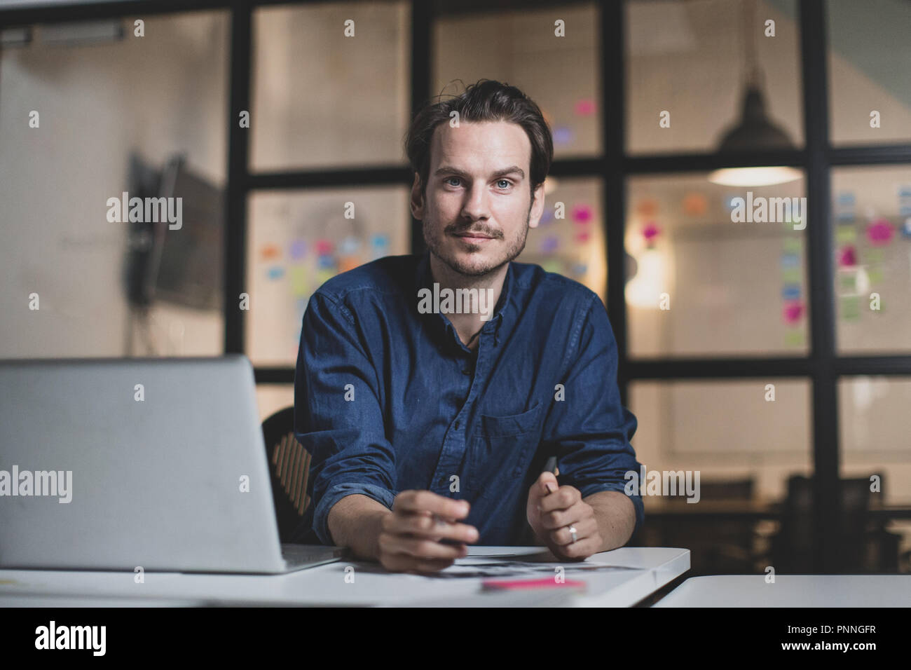 Portrait adult male working late in an office Stock Photo - Alamy