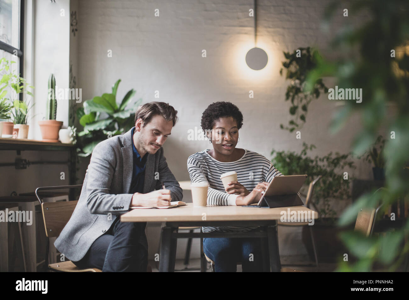 Coworkers writing hi-res stock photography and images - Alamy