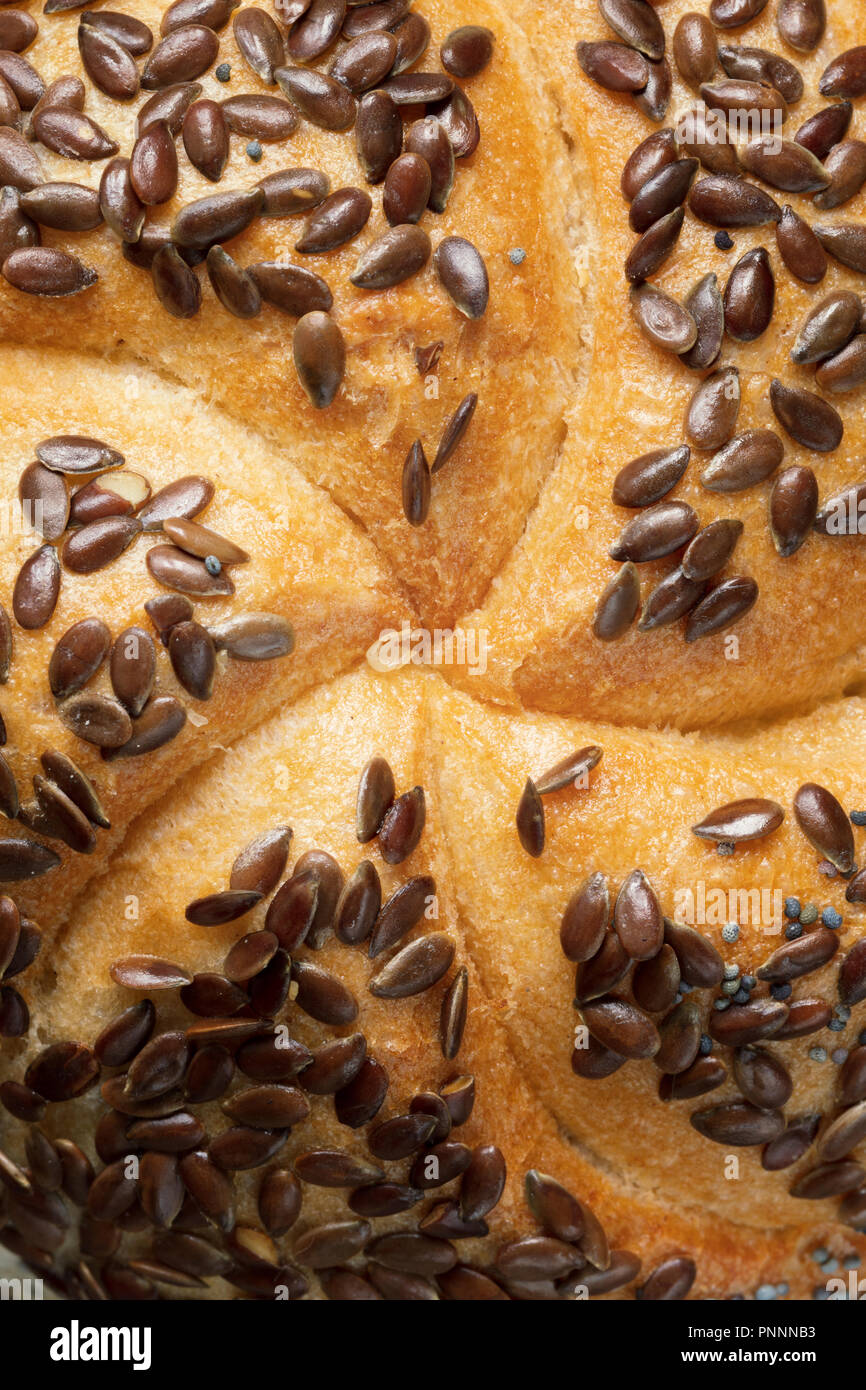 Single round bread roll with dark sesame seeds, top view, close up ...