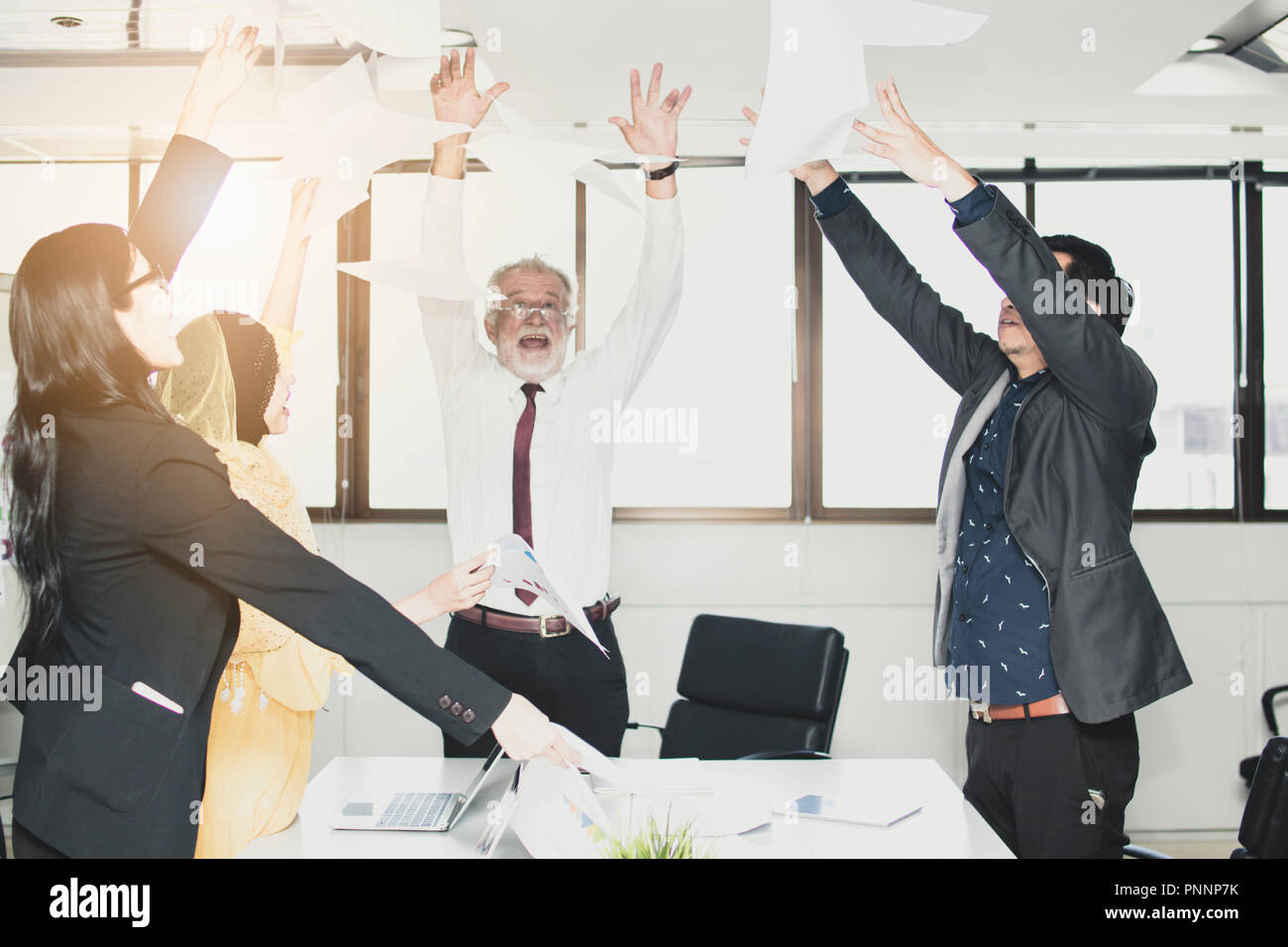 Group of business people throw paper up for celebration of successful ...