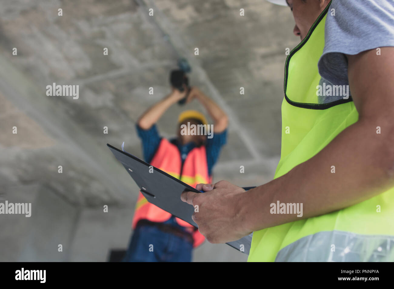 inspector checking worker working in construction site Stock Photo - Alamy