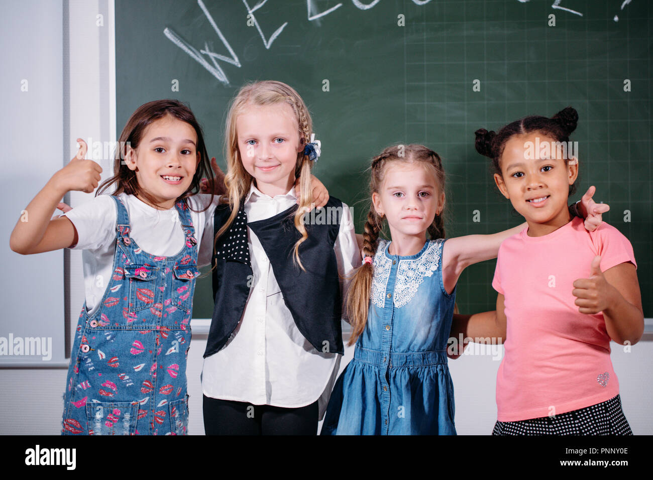 four School child with on board background Stock Photo - Alamy