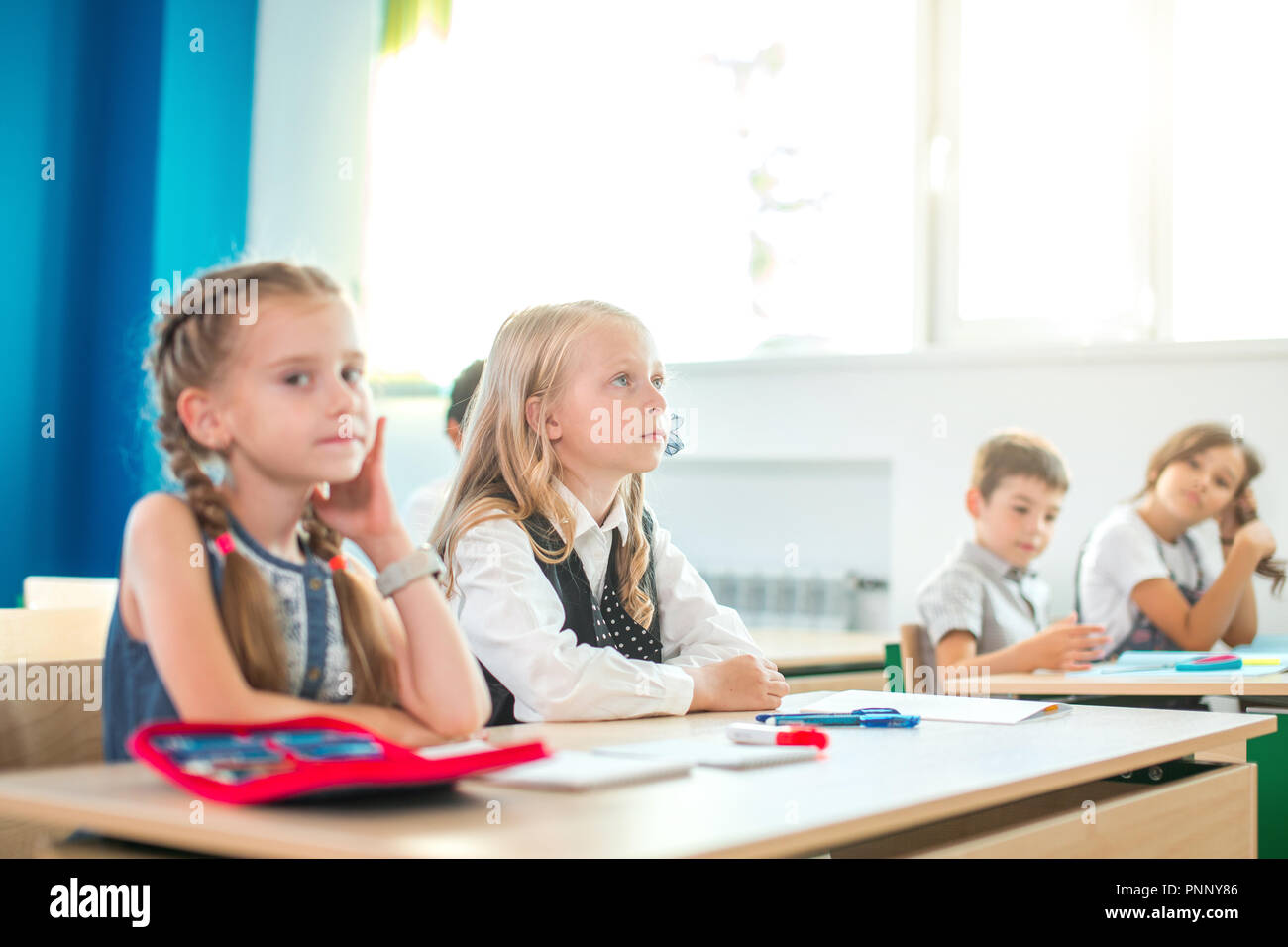 school children participating actively in class. Education, learning ...