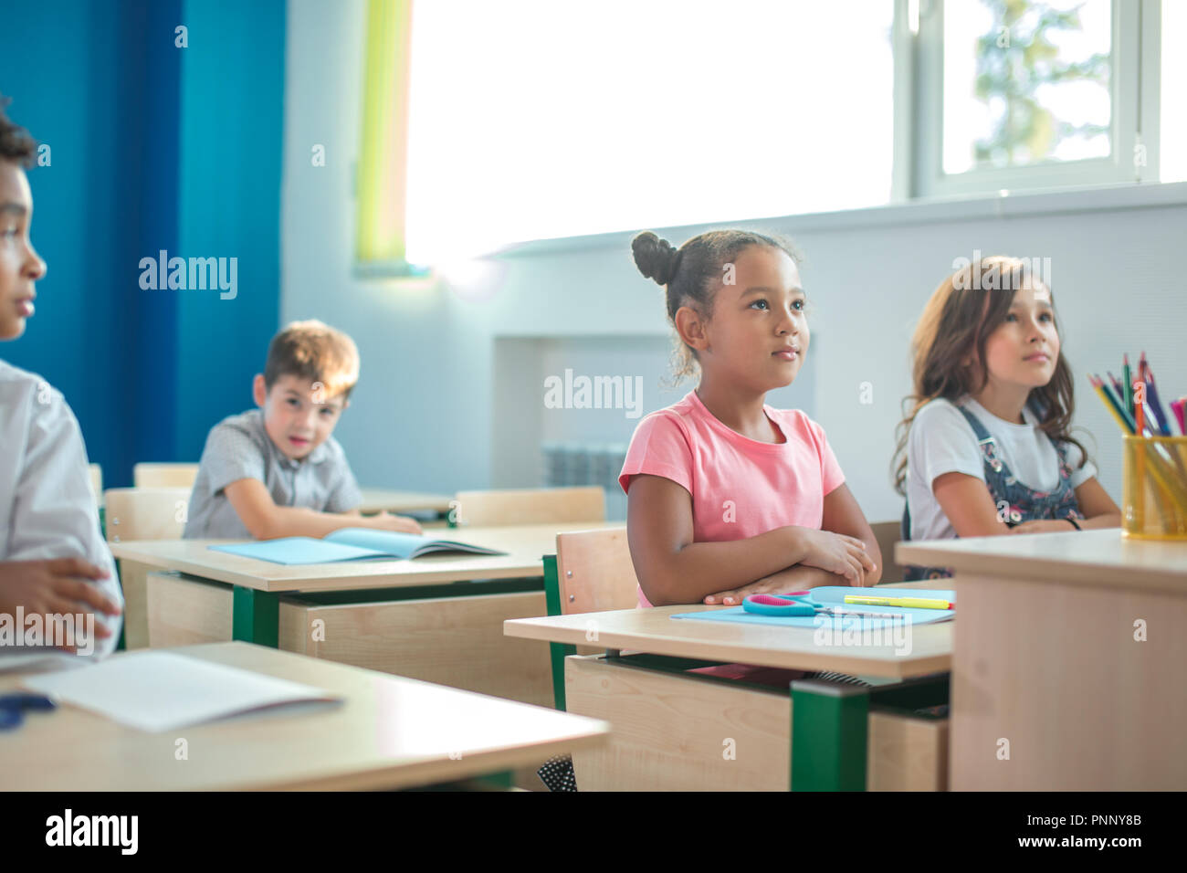 school children participating actively in class. Education, learning ...