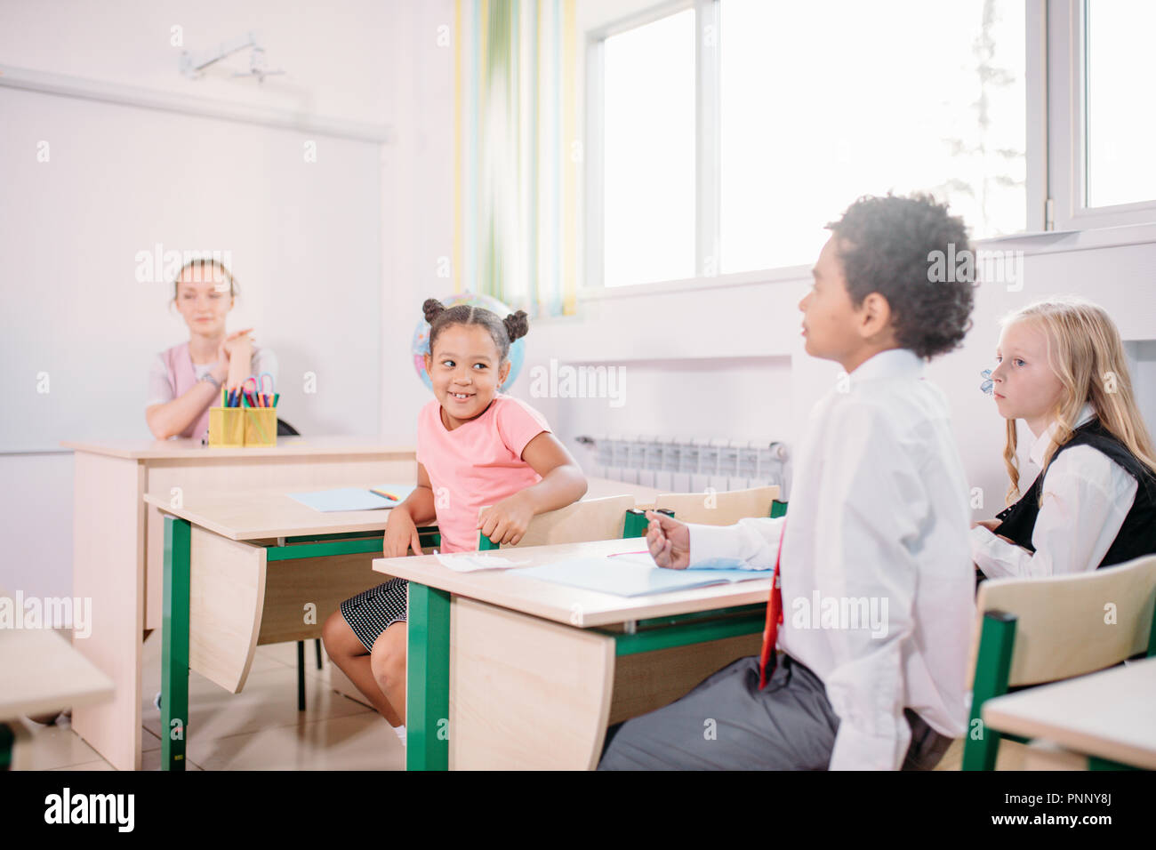 school children participating actively in class. Education, learning ...