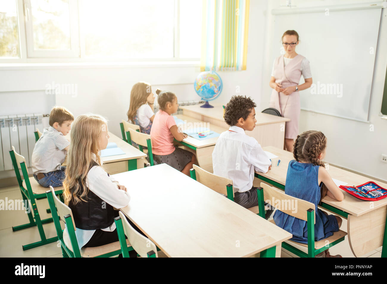 female teacher teaching group of teenagers in high school lesson Stock ...