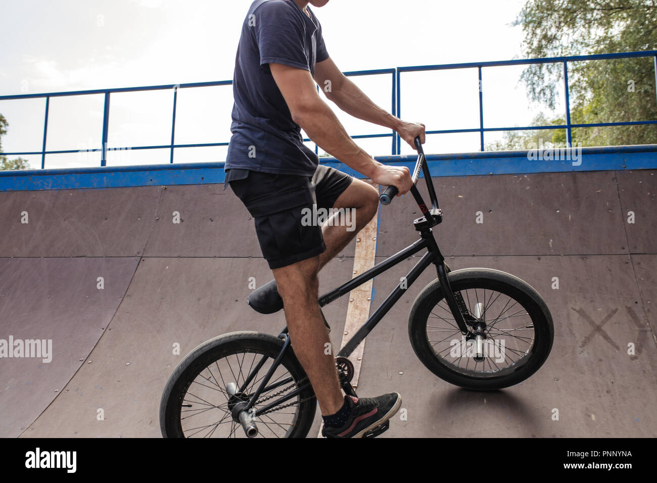 Freestyle male rider riding in skate park on bmx Stock Photo - Alamy