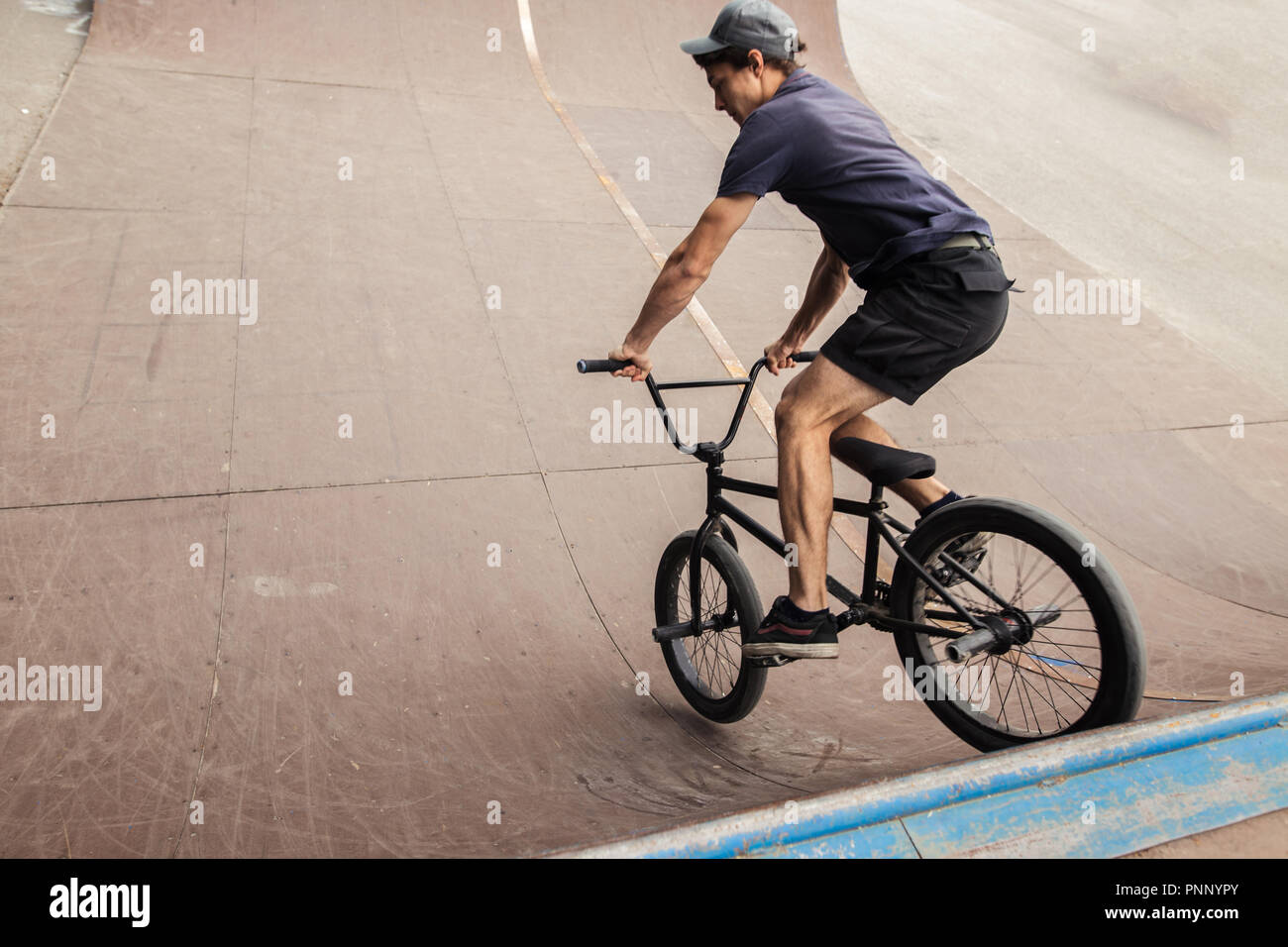 Freestyle male rider riding in skate park on bmx Stock Photo - Alamy