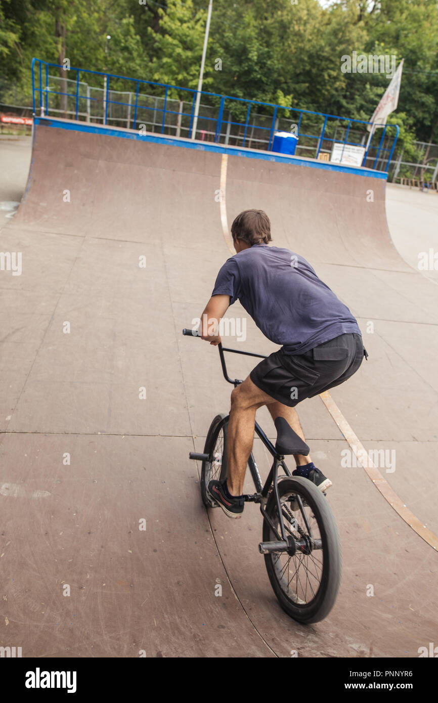 Freestyle male rider riding in skate park on bmx Stock Photo - Alamy