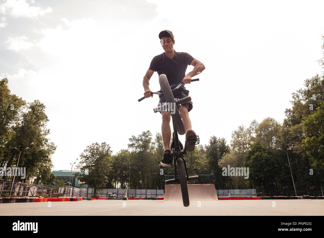 Boy jumping with his street-bike bmx in skate park Stock Photo - Alamy